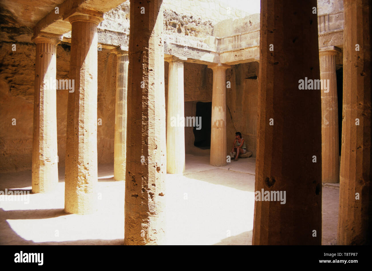 Female visitor inside a burial chamber with fluted doric columns, Tombs ...