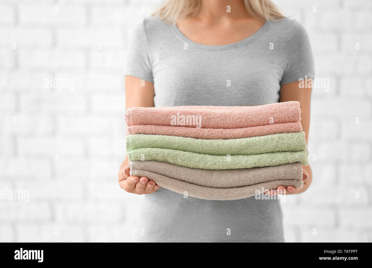 Holding dry towels hi-res stock photography and images - Alamy