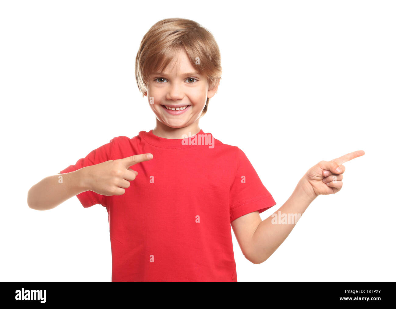 Little boy in t-shirt pointing at something on white background Stock ...