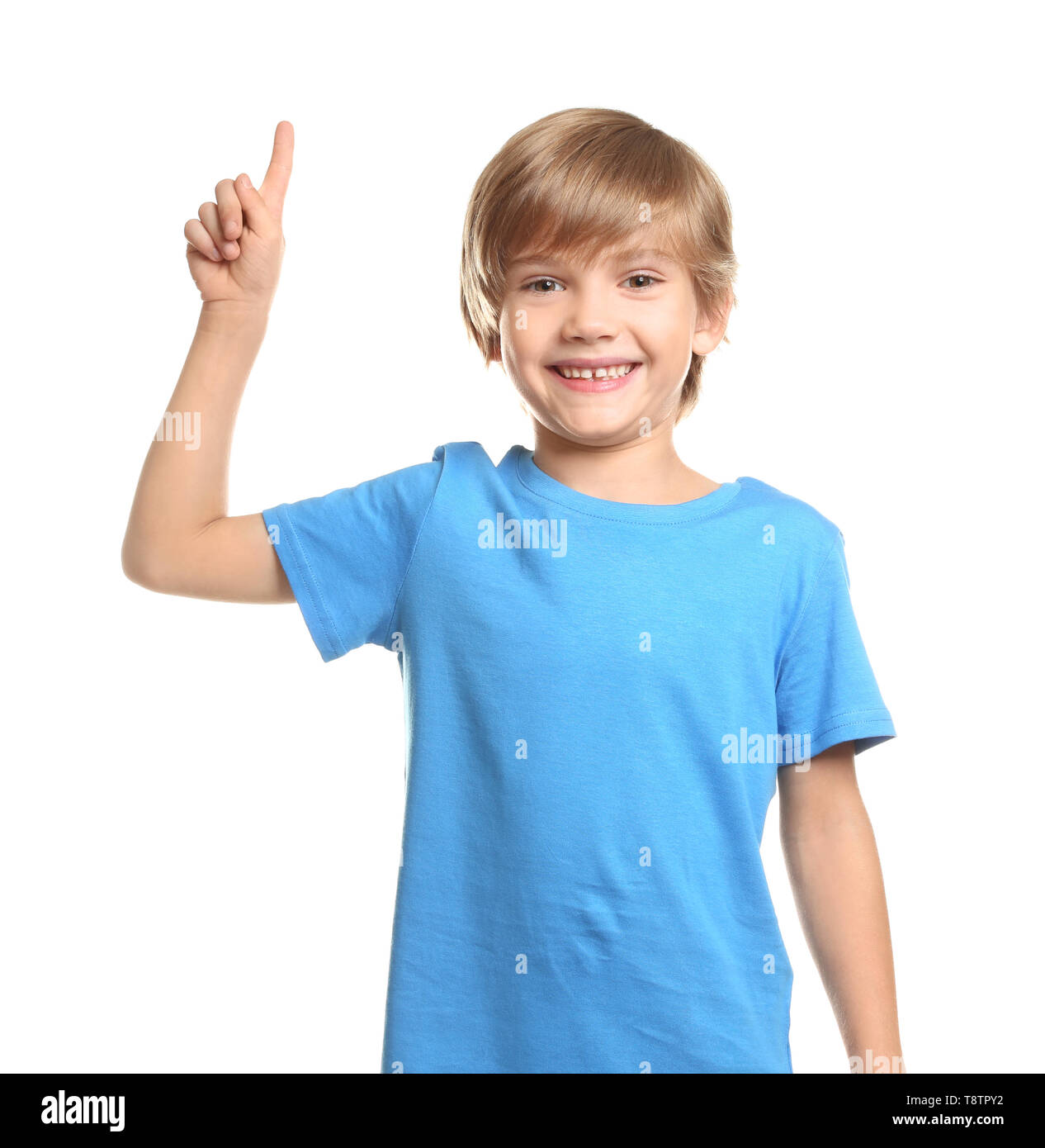 Little boy in t-shirt and with raised index finger on white background ...
