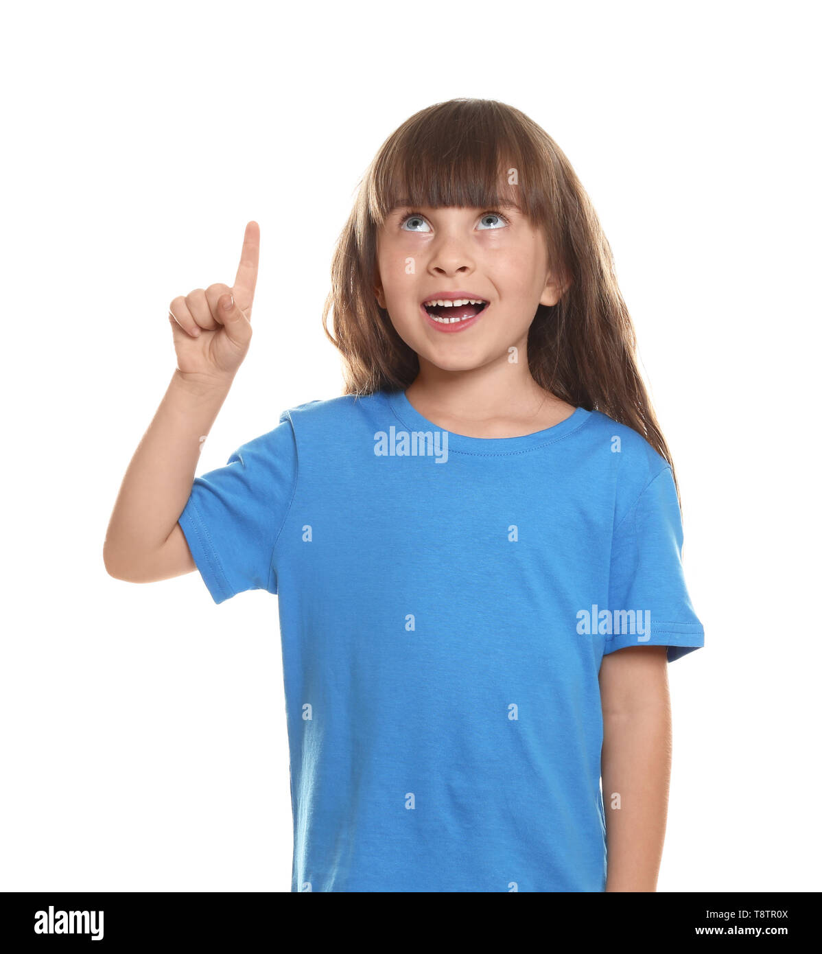Little girl in t-shirt and with raised index finger on white background ...