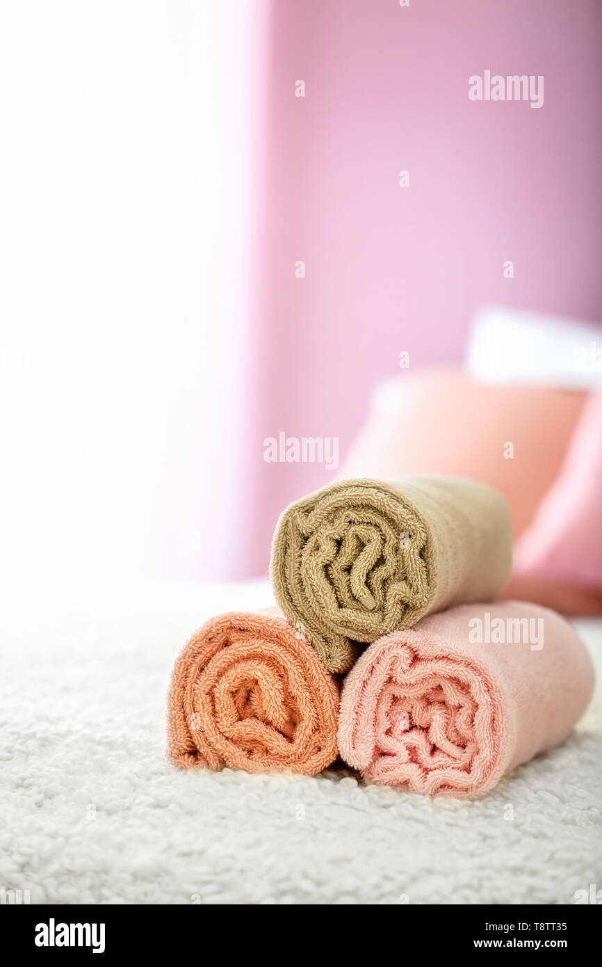 Clean soft towels on bed Stock Photo - Alamy