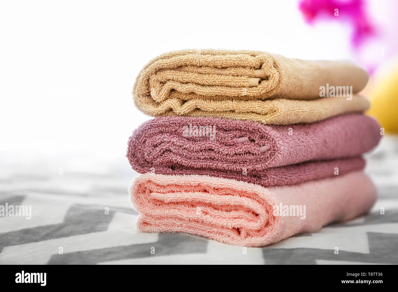 Stack of clean soft towels on bed Stock Photo - Alamy