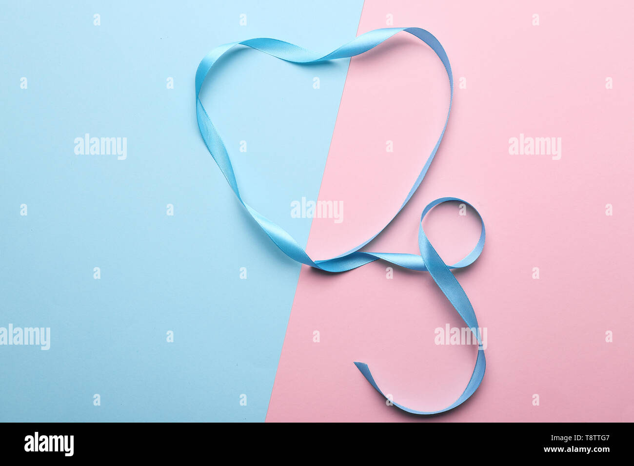 Curled blue ribbon on color background Stock Photo - Alamy