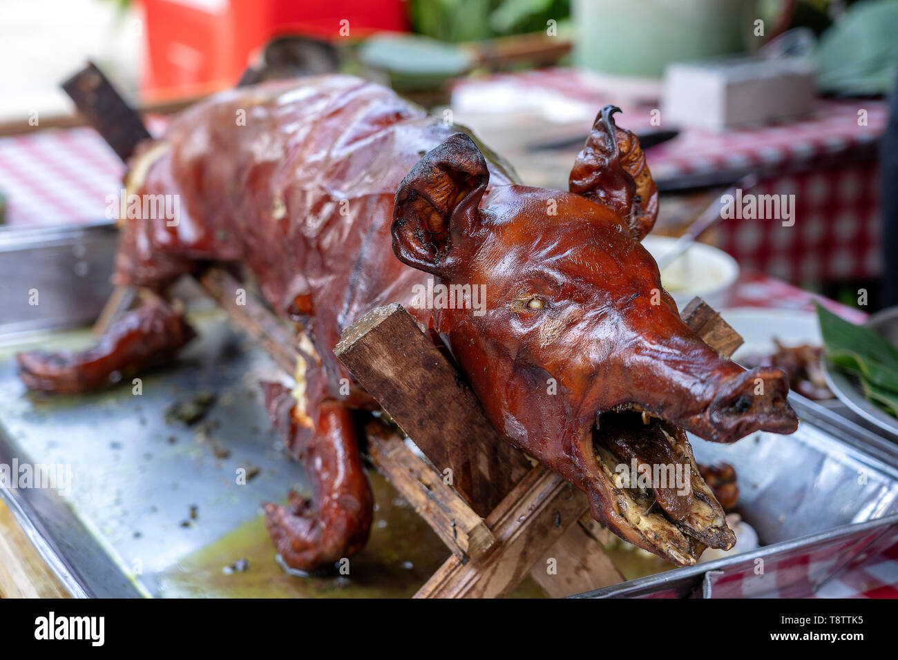 Roasted pig on the traditional barbecue. Grilled pig on the market of ...