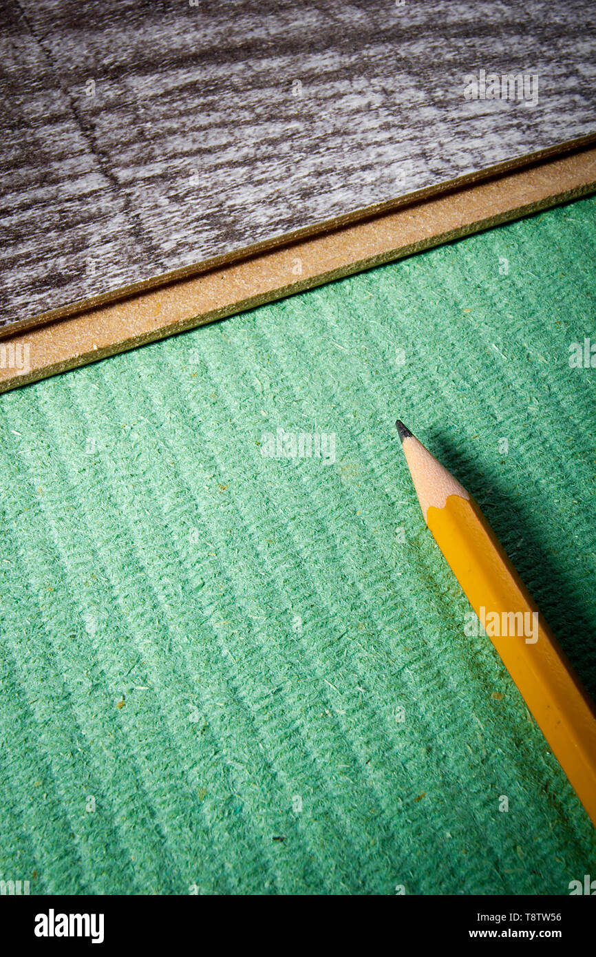 Laying laminate flooring. Laminate and substrate green Stock Photo - Alamy