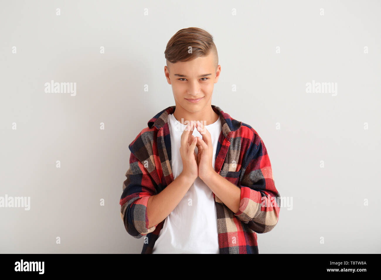 Cunning teenage boy on white background Stock Photo - Alamy