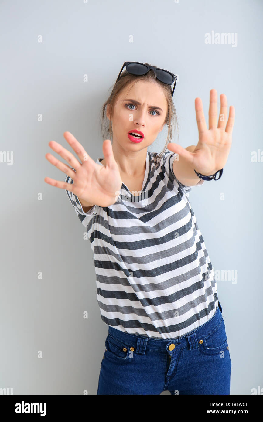 Beautiful young woman rejecting something on light background Stock ...