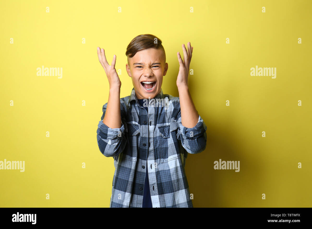 Aggressive teenage boy on color background Stock Photo - Alamy