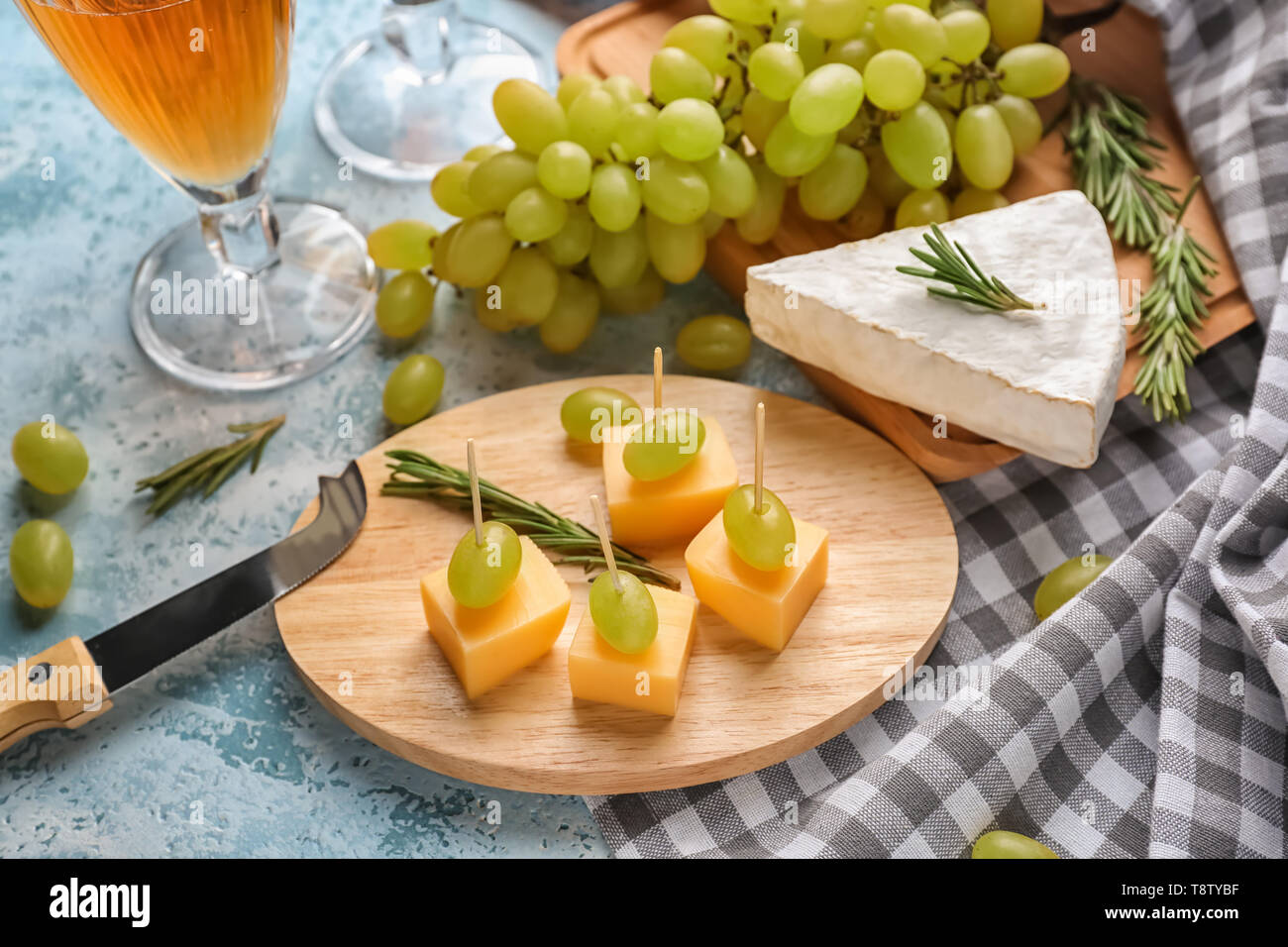 Wooden board with delicious canapes on color table Stock Photo - Alamy