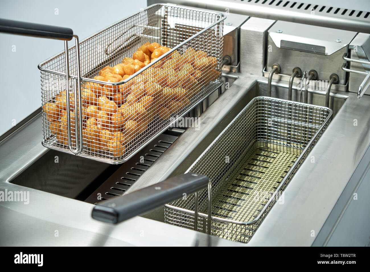 Industrial Deep Fat In the basket for the deep fat is cooked potato ...