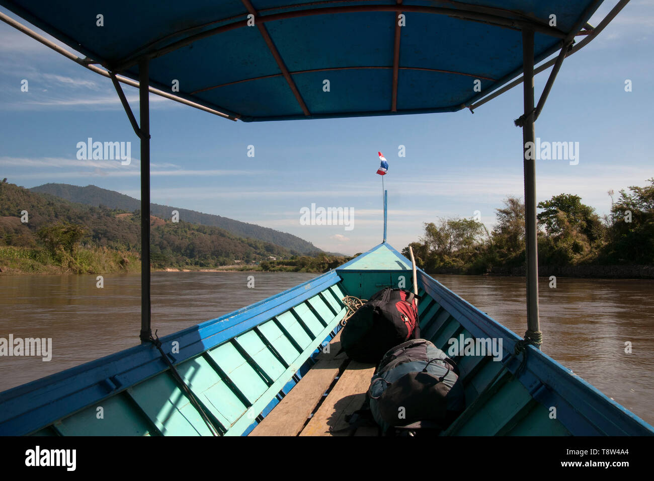 Kok river Thailand, traveling along tranquil stretch of river in long ...