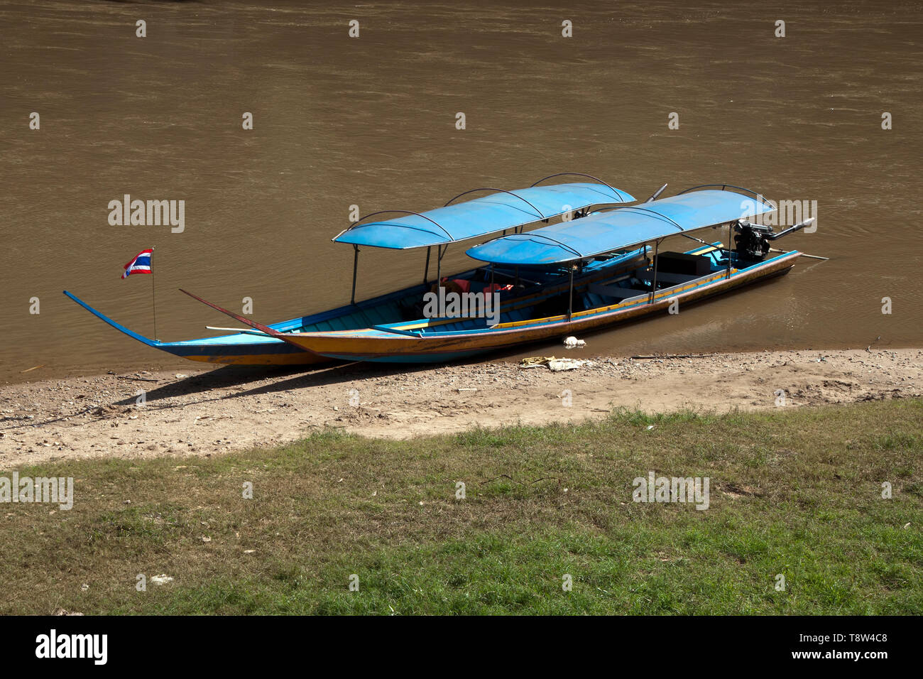 Kok River Thailand, moored long boats with shade roof Stock Photo - Alamy