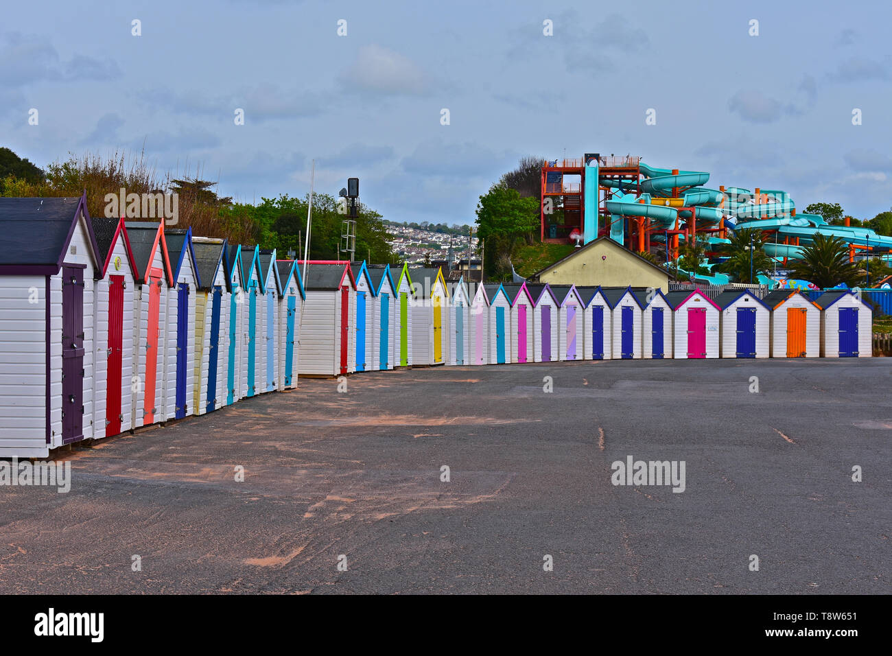 A colourful row of brightly coloured beach huts on the promenade ...
