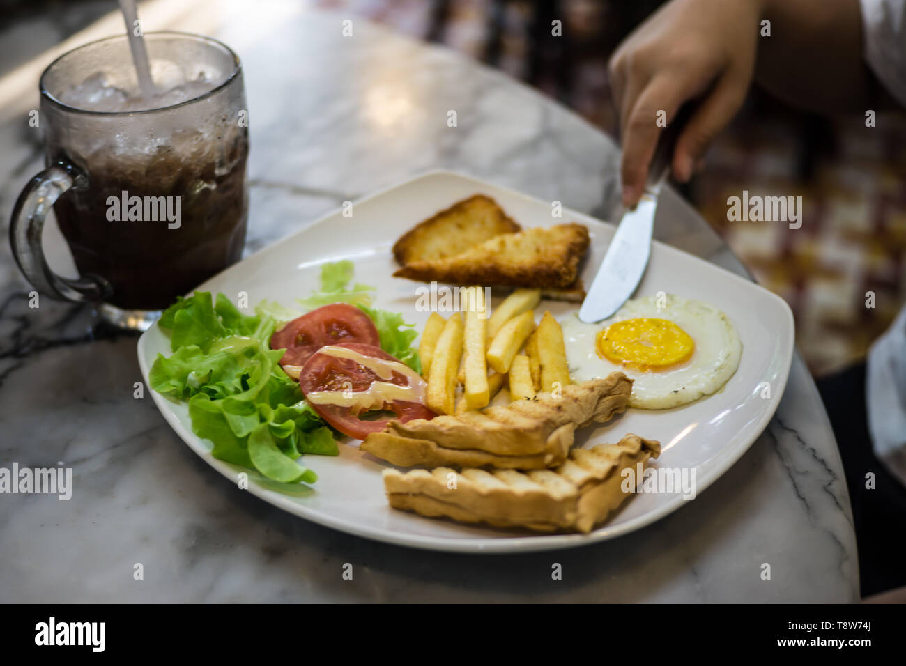 Breakfast set with meal and iced coffee set in restaurant Stock Photo ...