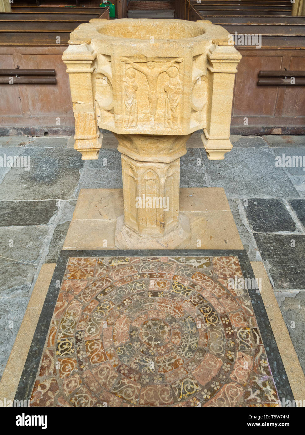 the 15th century hamstone octagonal font in the church of St Peter and ...