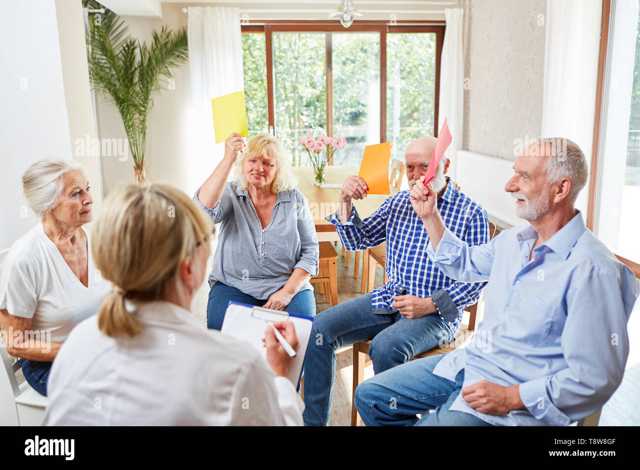 Seniors do an exercise together in a group therapy workshop Stock Photo ...