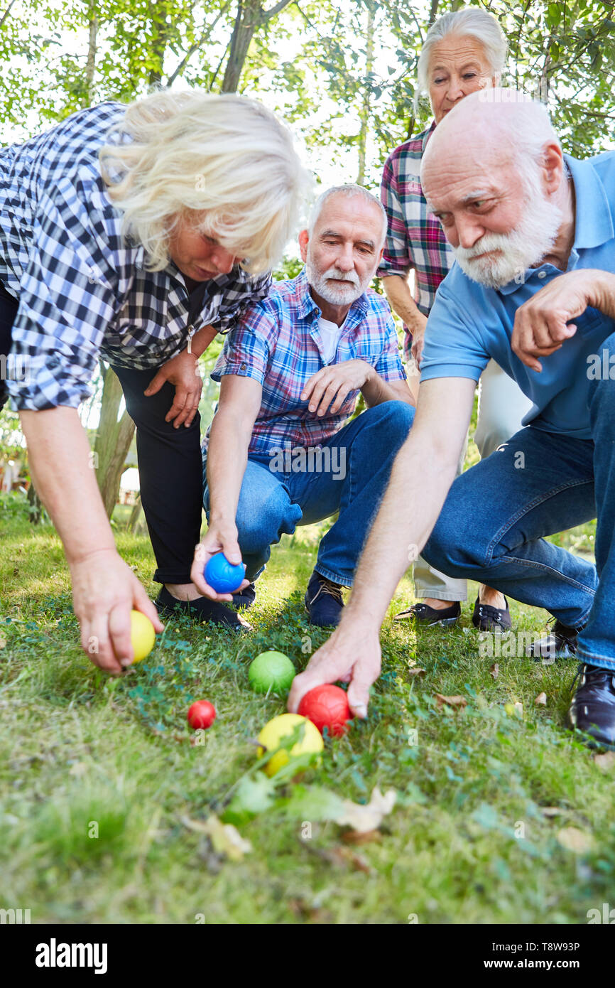 Seniors playing boules as a competition in the garden in the retirement ...