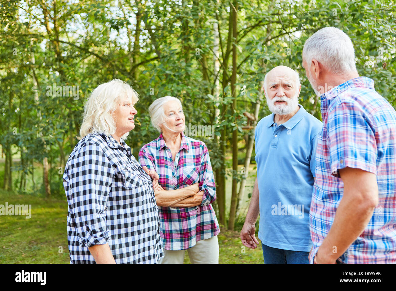 Senior group having a conversation on a nature trip Stock Photo - Alamy
