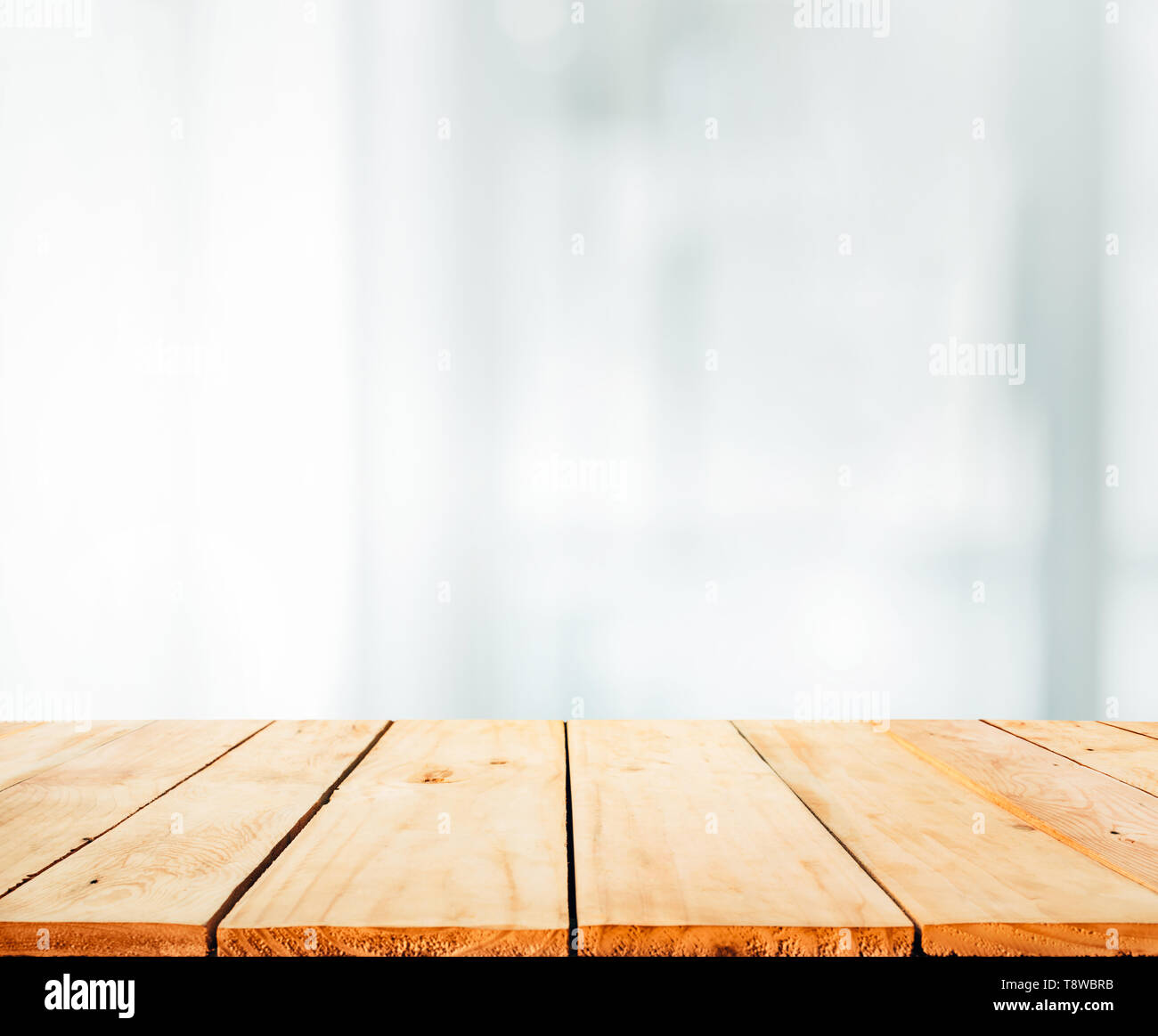 Wood table top on blur window glass,wall background with city view.For ...