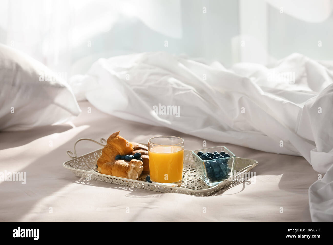 Tray with delicious breakfast on bed Stock Photo - Alamy