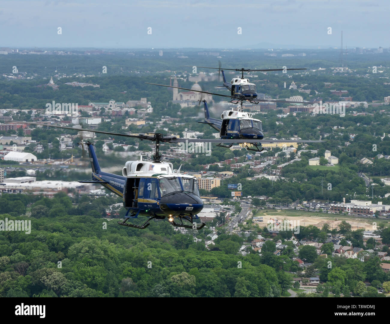 Members of the 1st Helicopter Squadron fly UH-1 Hueys over Washington ...