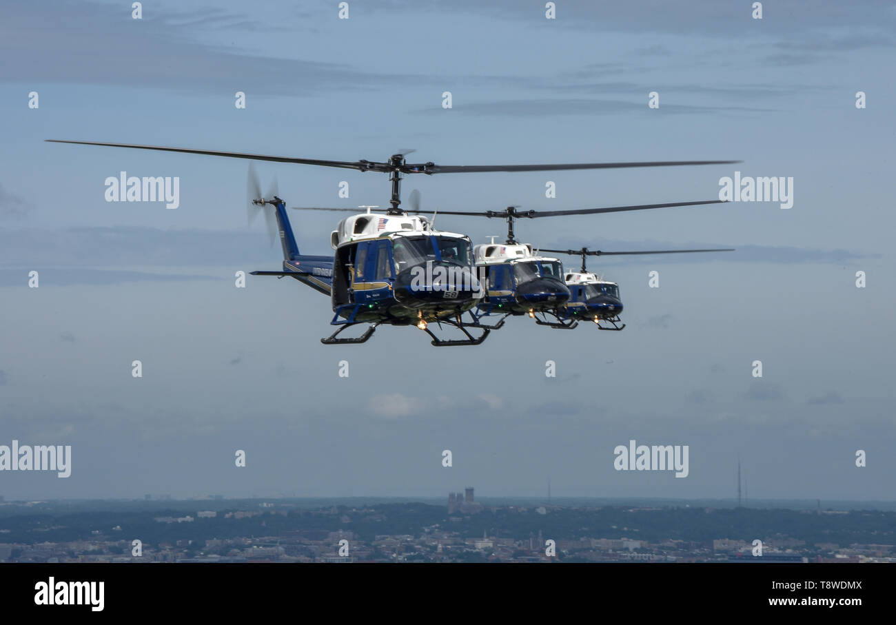 Members of the 1st Helicopter Squadron fly UH-1 Hueys over Washington ...