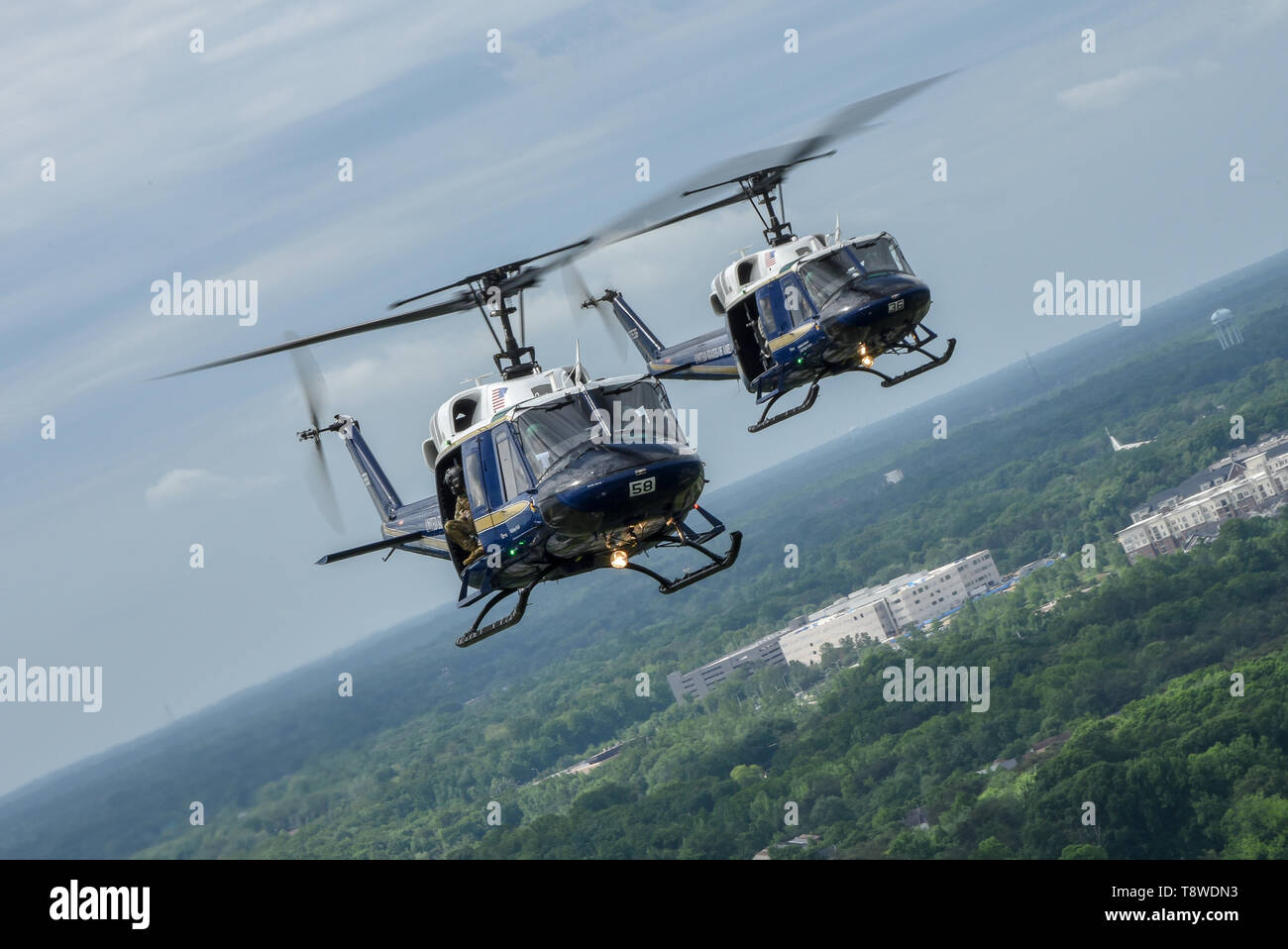 Members of the 1st Helicopter Squadron fly UH-1 Hueys over Washington ...