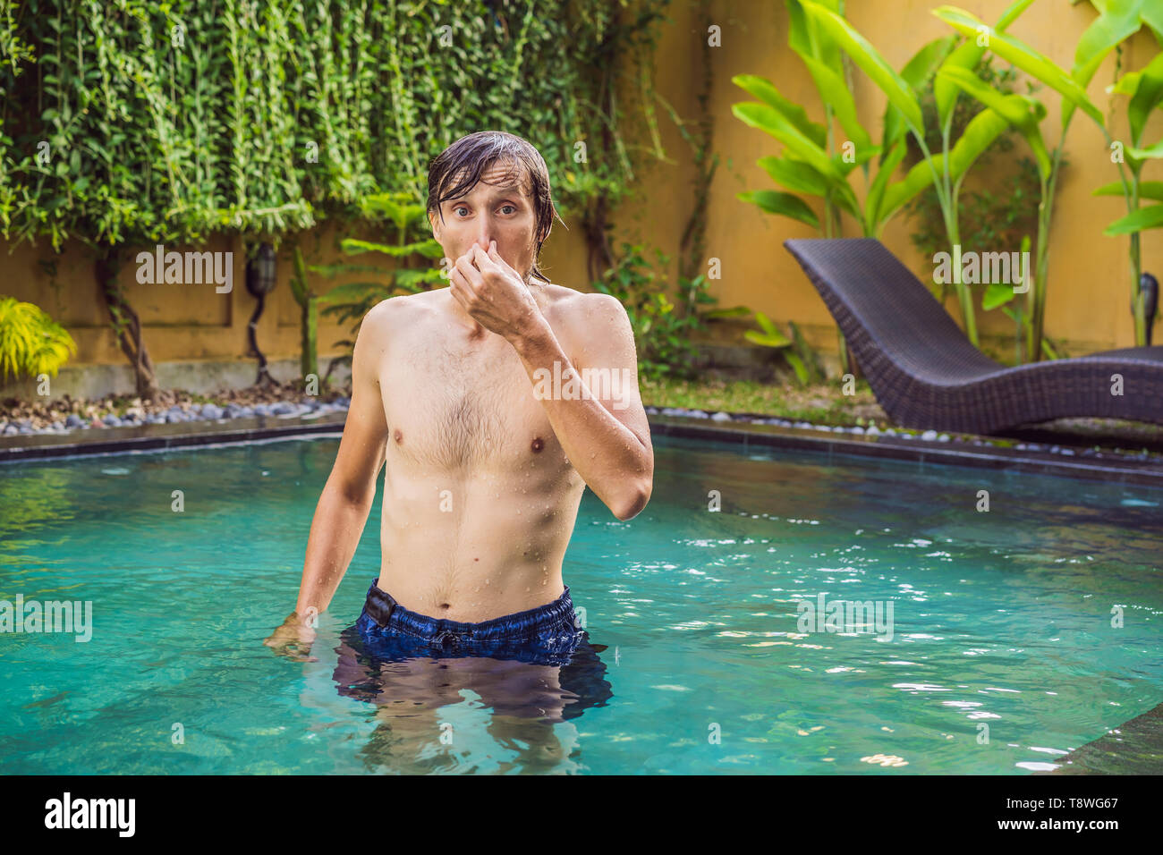 Young man with disgust on his face pinches nose, something stinks, very ...