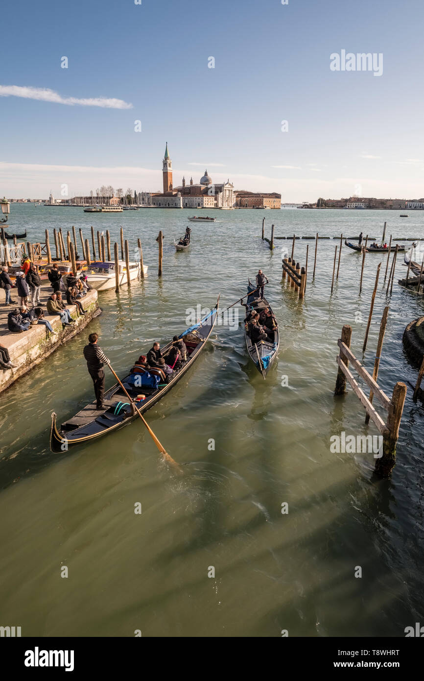 Boatman are rowing Gondolas, the traditional venetian rowing boats, on ...