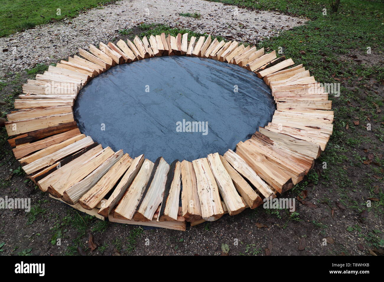 first layer of round wood pile Stock Photo - Alamy