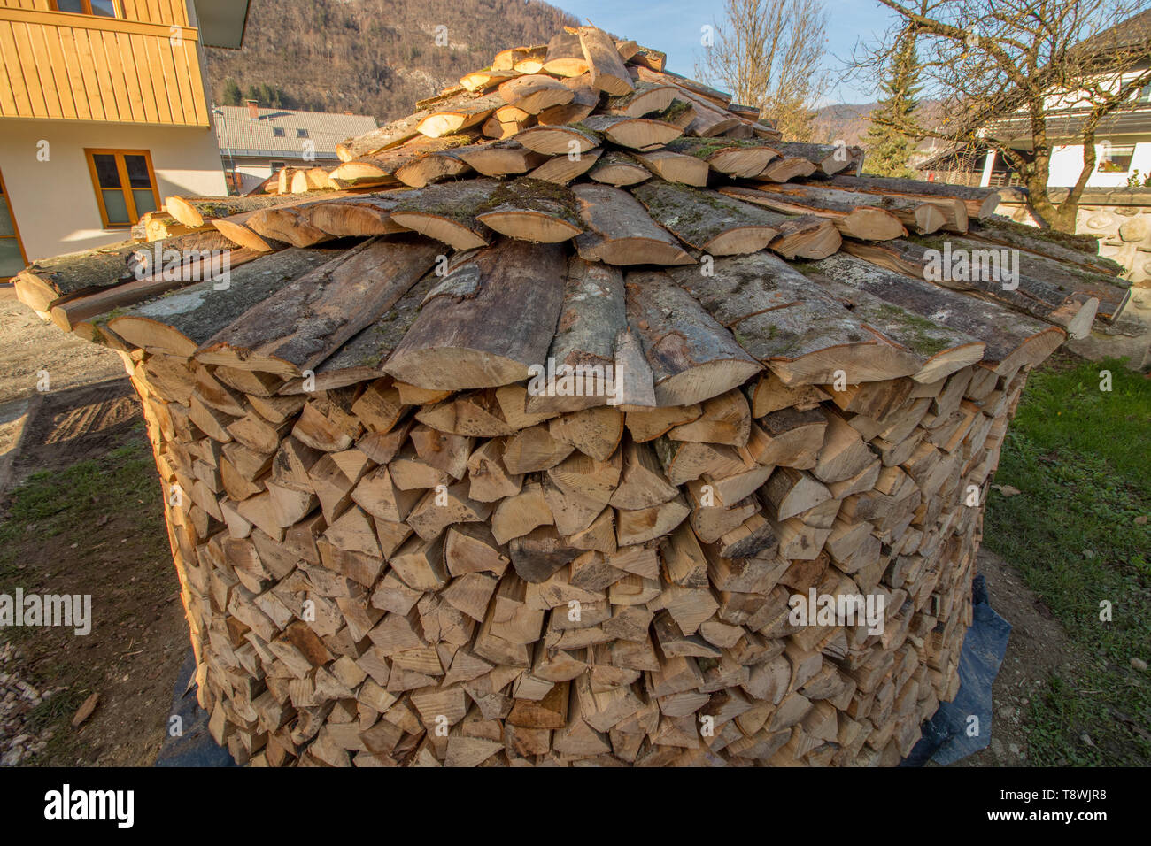 round wood pile with roof Stock Photo - Alamy