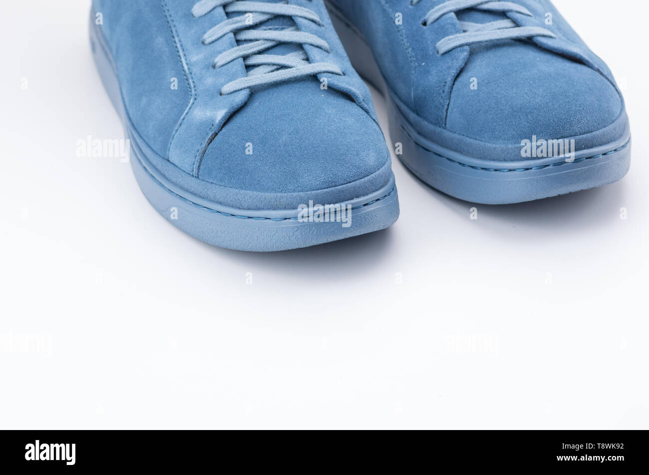blue sneaker shoes on a blank surface with copy space Stock Photo - Alamy