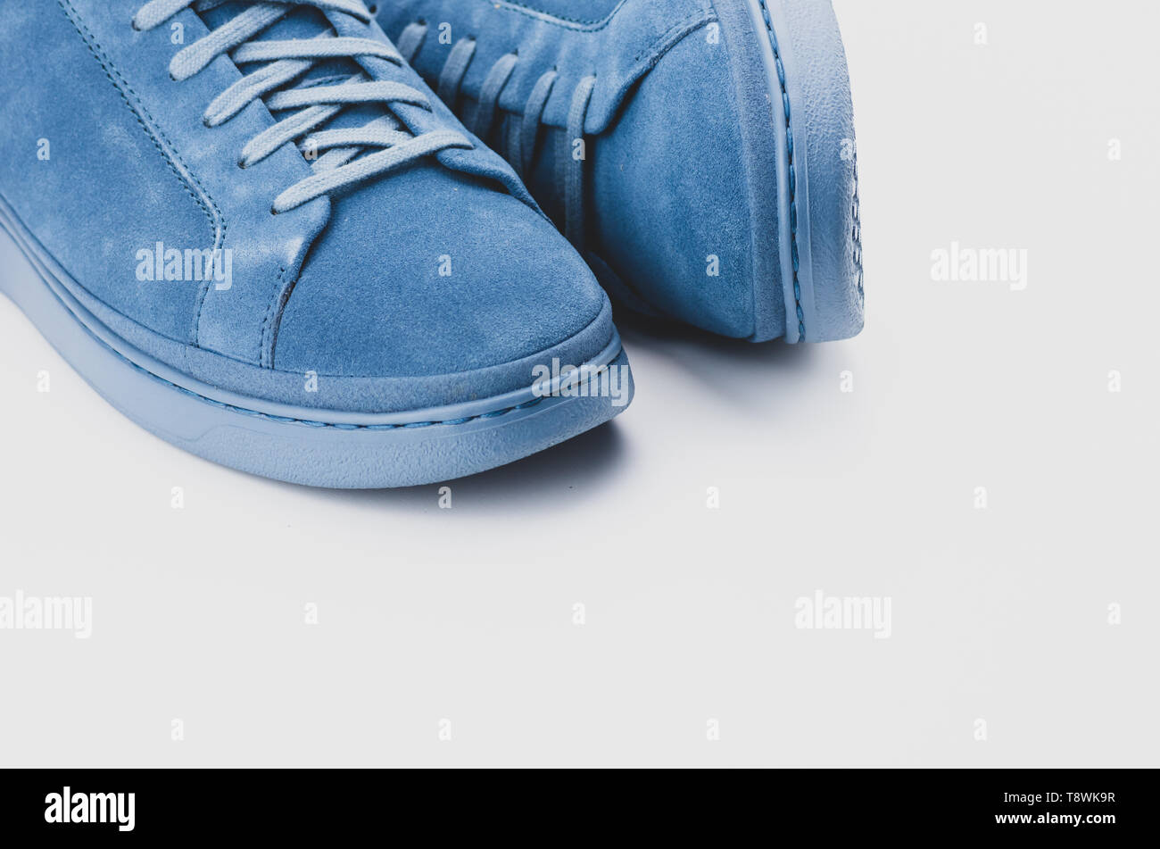 blue sneaker shoes on a blank surface with copy space Stock Photo - Alamy