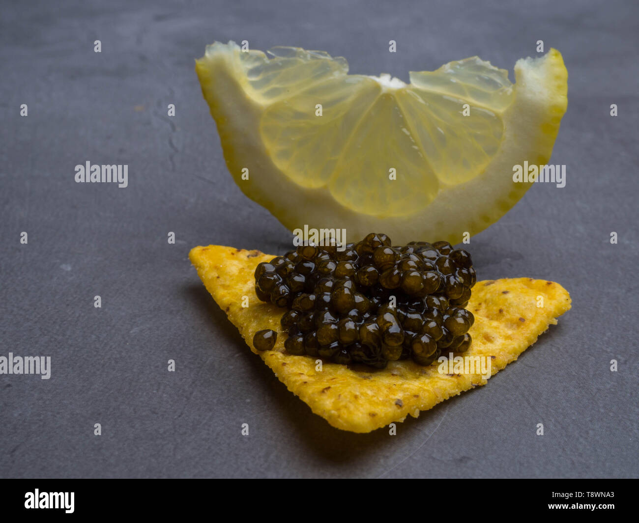 Black caviar and lemon, gourmet food, appetizer close up Stock Photo ...