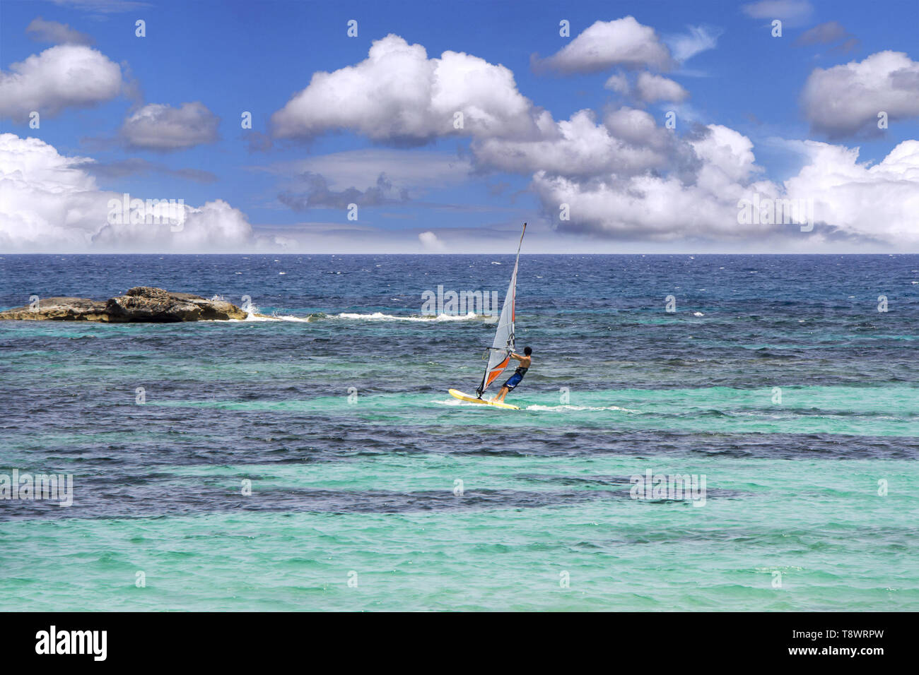 Windsurfing on sea and blue sky background hi-res stock photography and ...