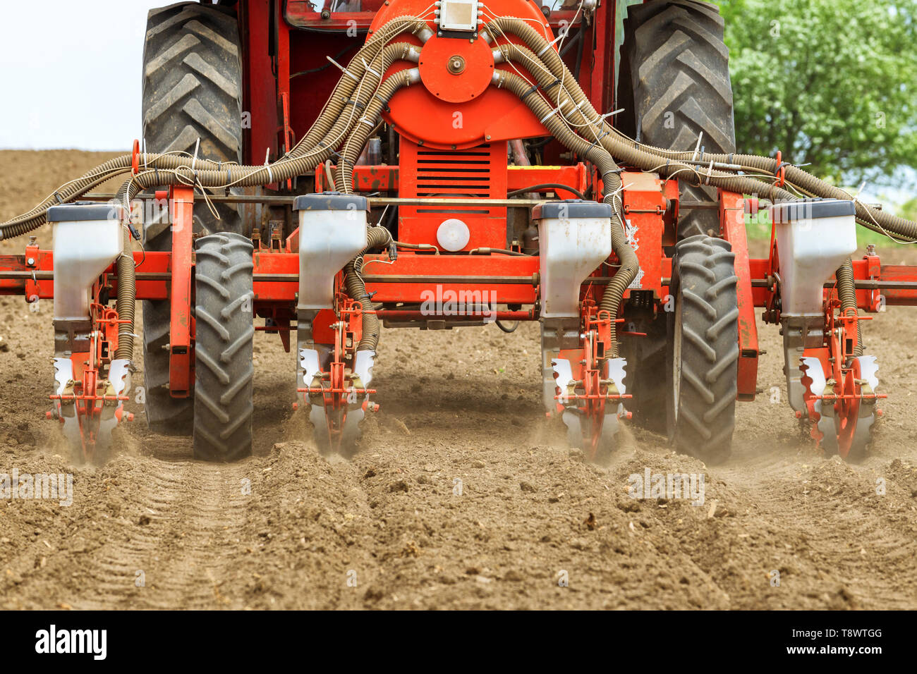 Tractor with mounted crop seeder planting corn seed in field Stock ...