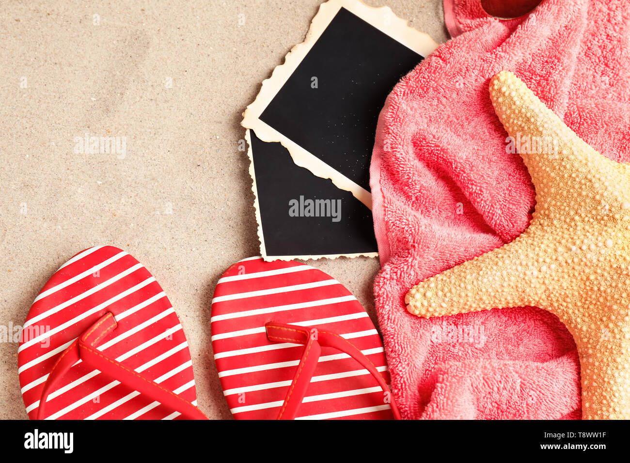 Set of beach items with photo cards on sand Stock Photo - Alamy