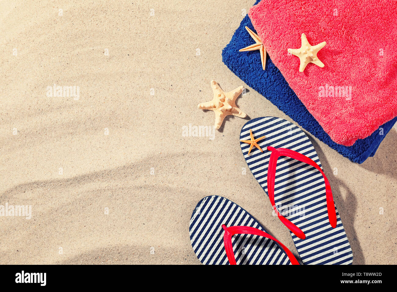 Set of beach items with starfishes on sand Stock Photo - Alamy