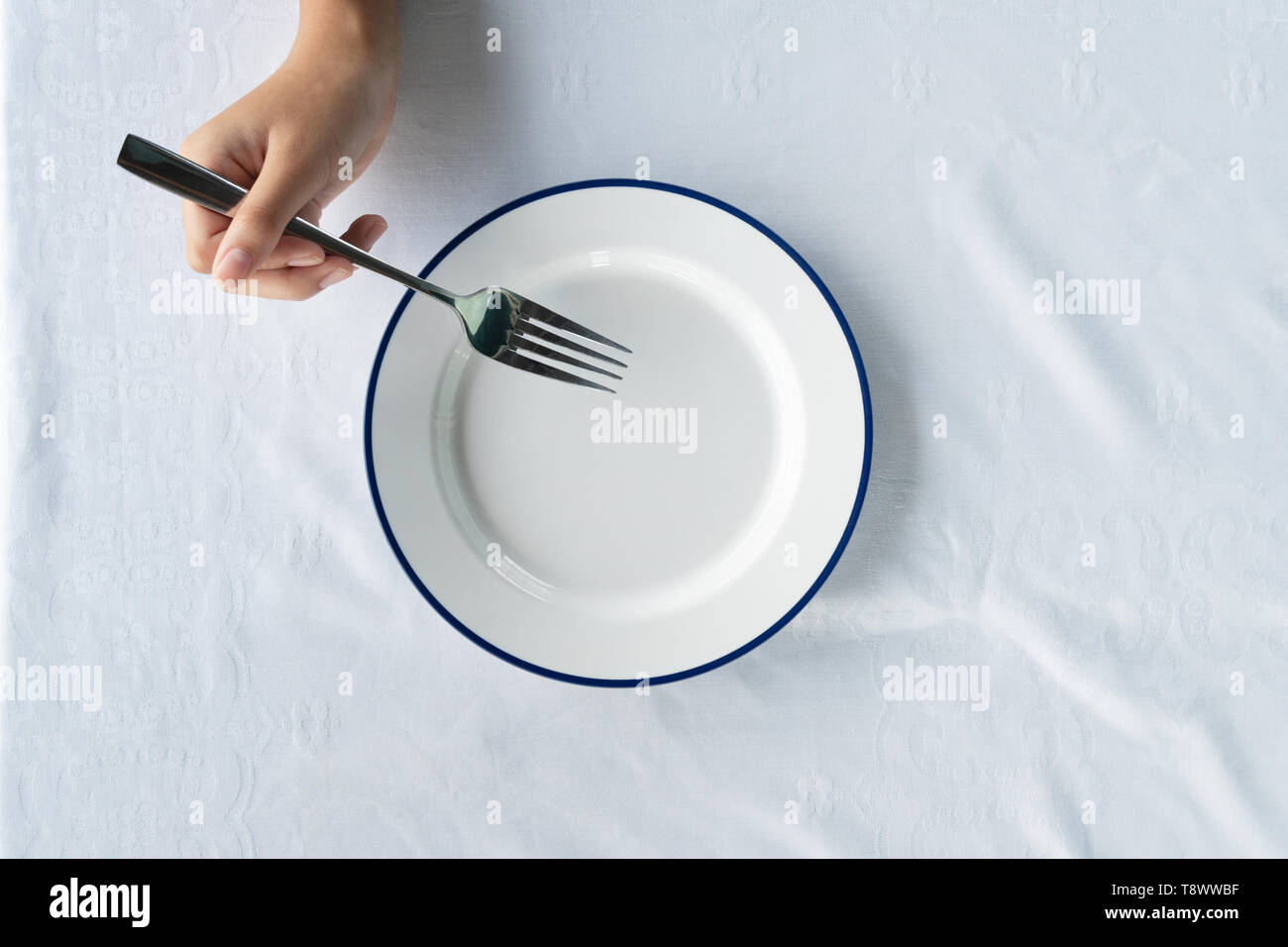 Hand holding fork white background hi-res stock photography and images ...
