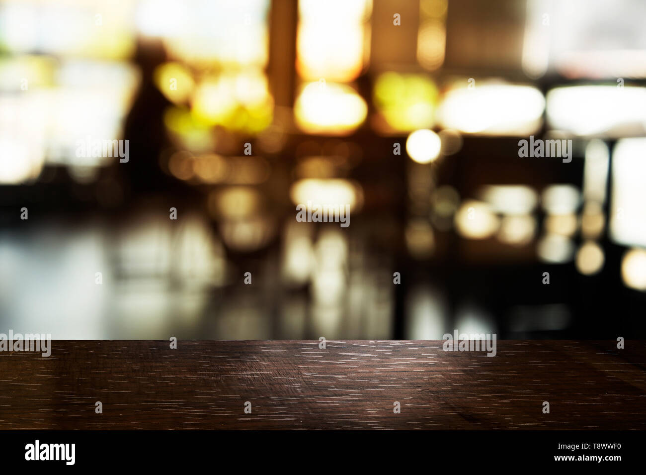 top of black table wood with blur light in bar or restaurant with ...