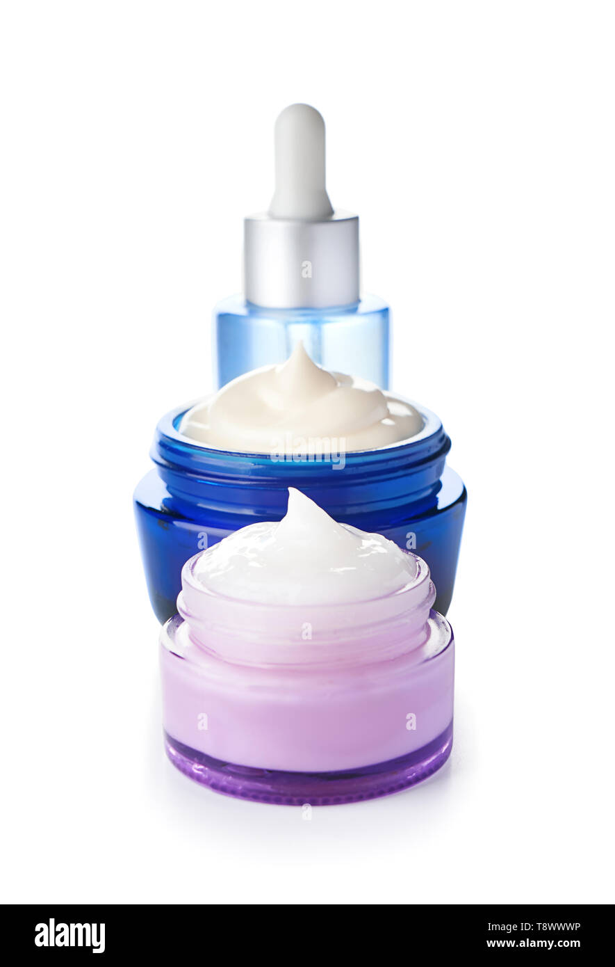 Jars with body cream and bottle of lotion on white background Stock ...