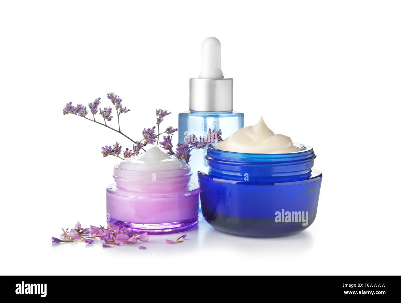 Jars with body cream and bottle of lotion on white background Stock ...