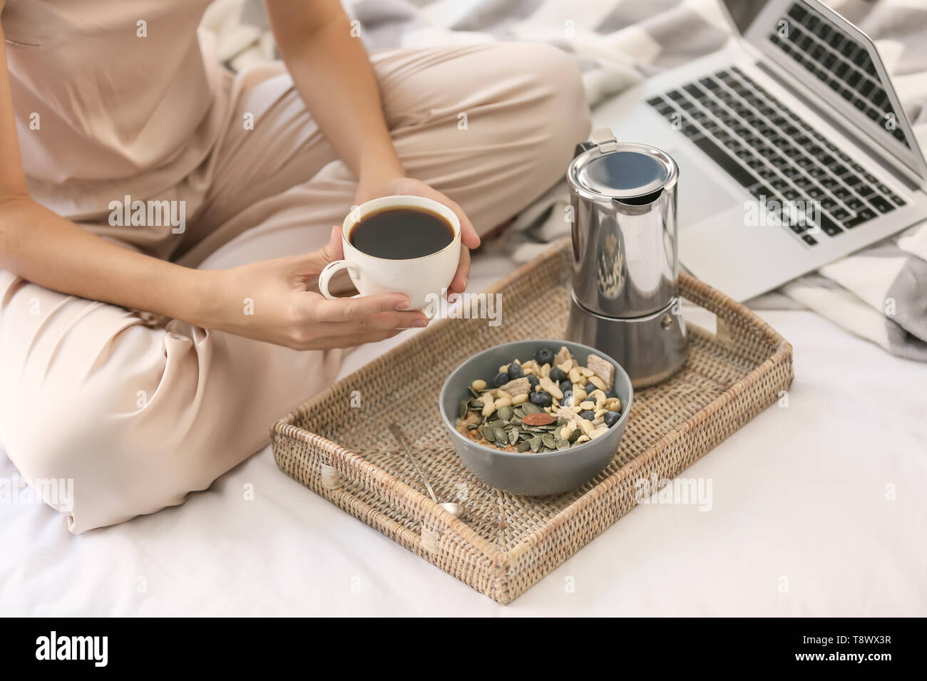 Young woman having delicious breakfast on bed Stock Photo - Alamy