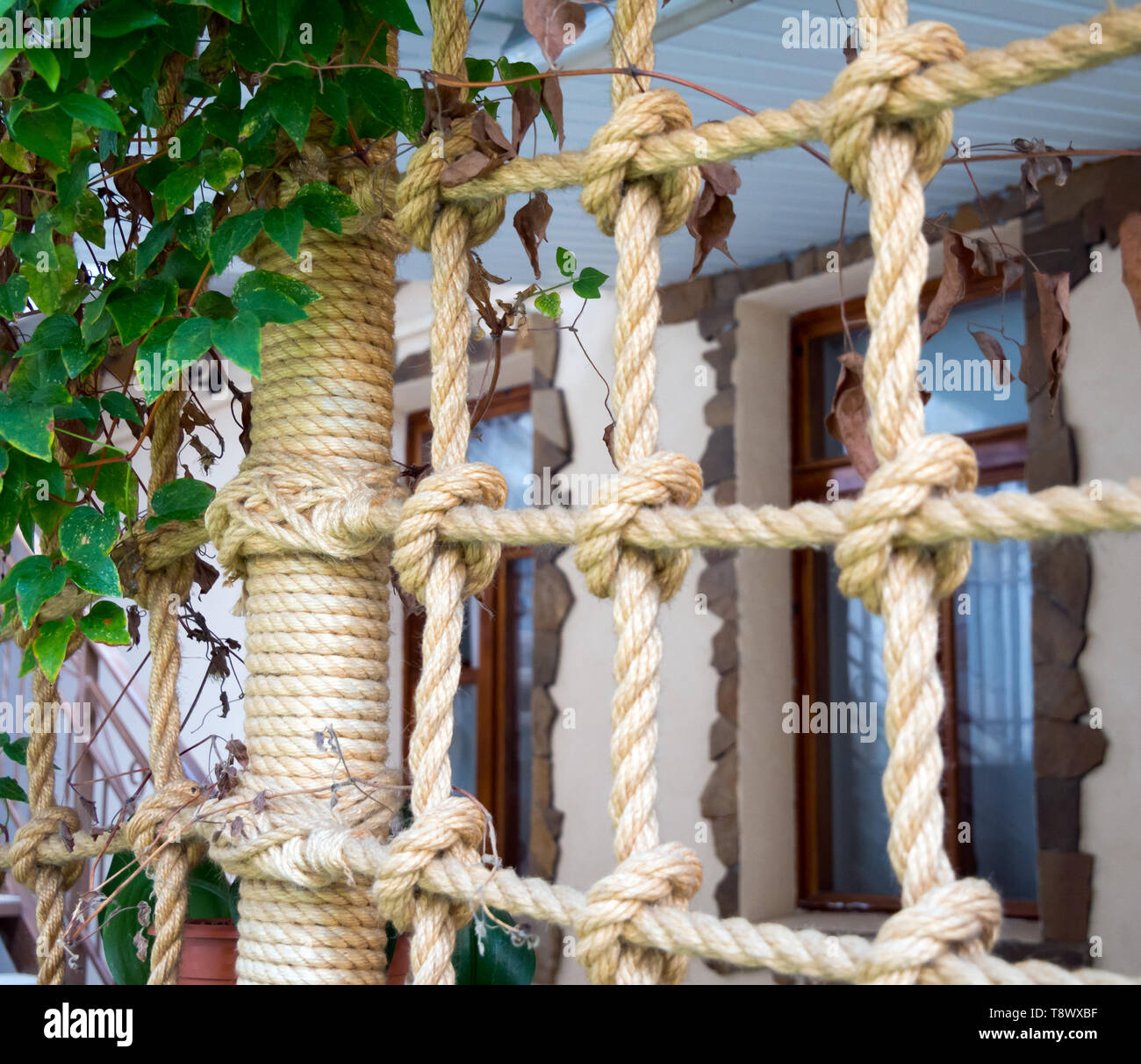 Grid of ropes as a frame for the veranda Stock Photo - Alamy