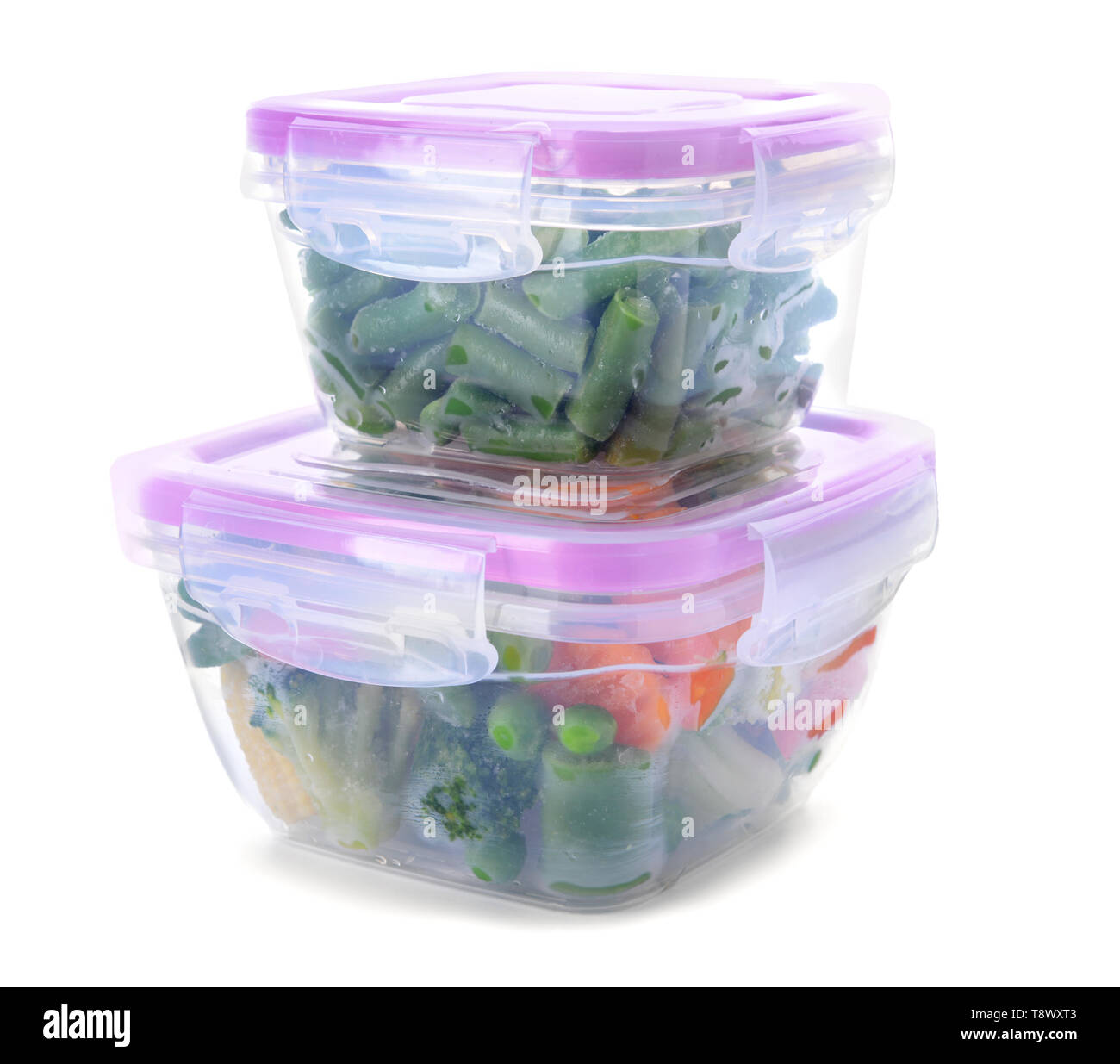 Plastic containers with frozen vegetables on white background Stock ...