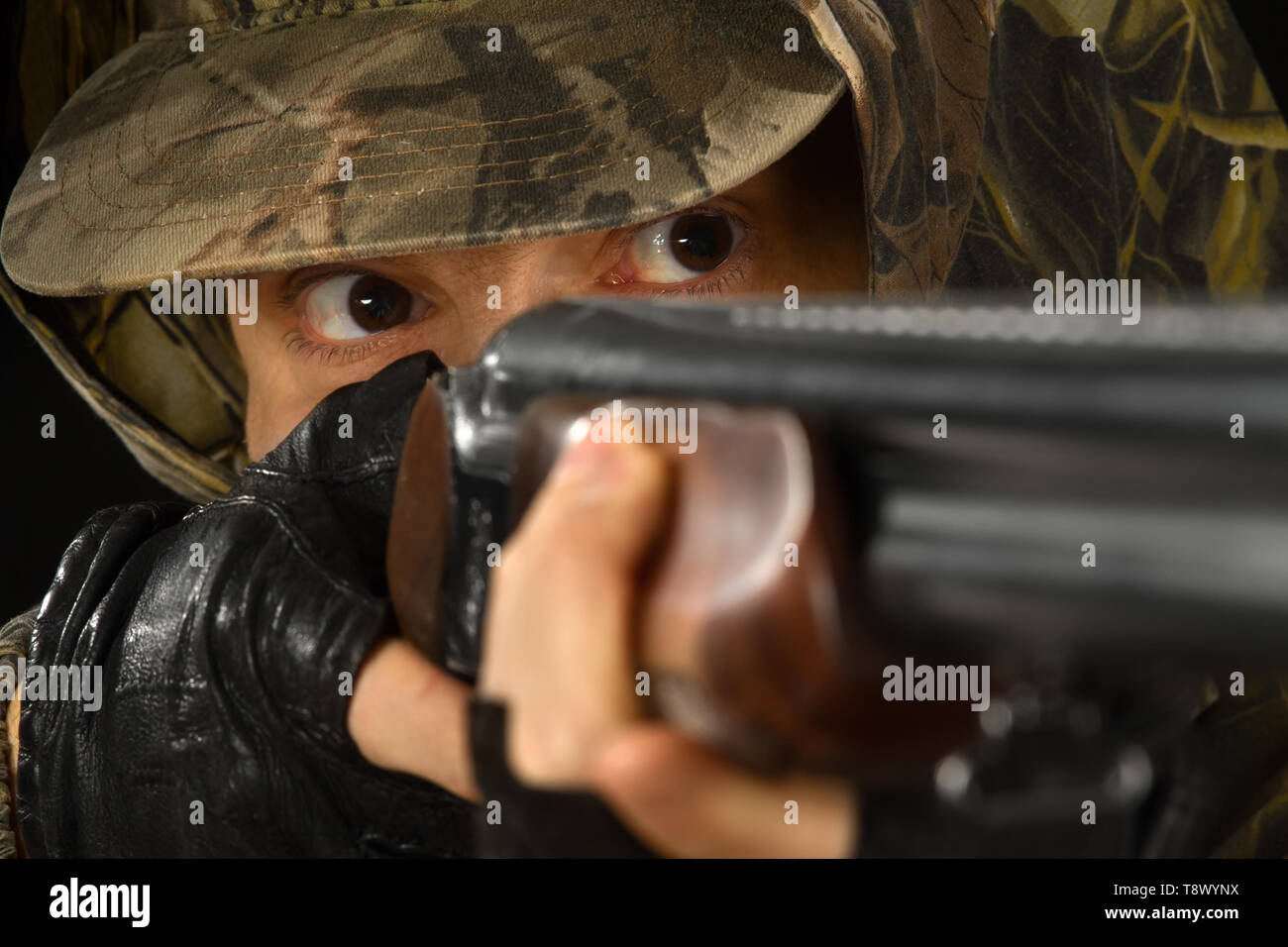 the face of a hunter aiming a shotgun, closeup Stock Photo - Alamy