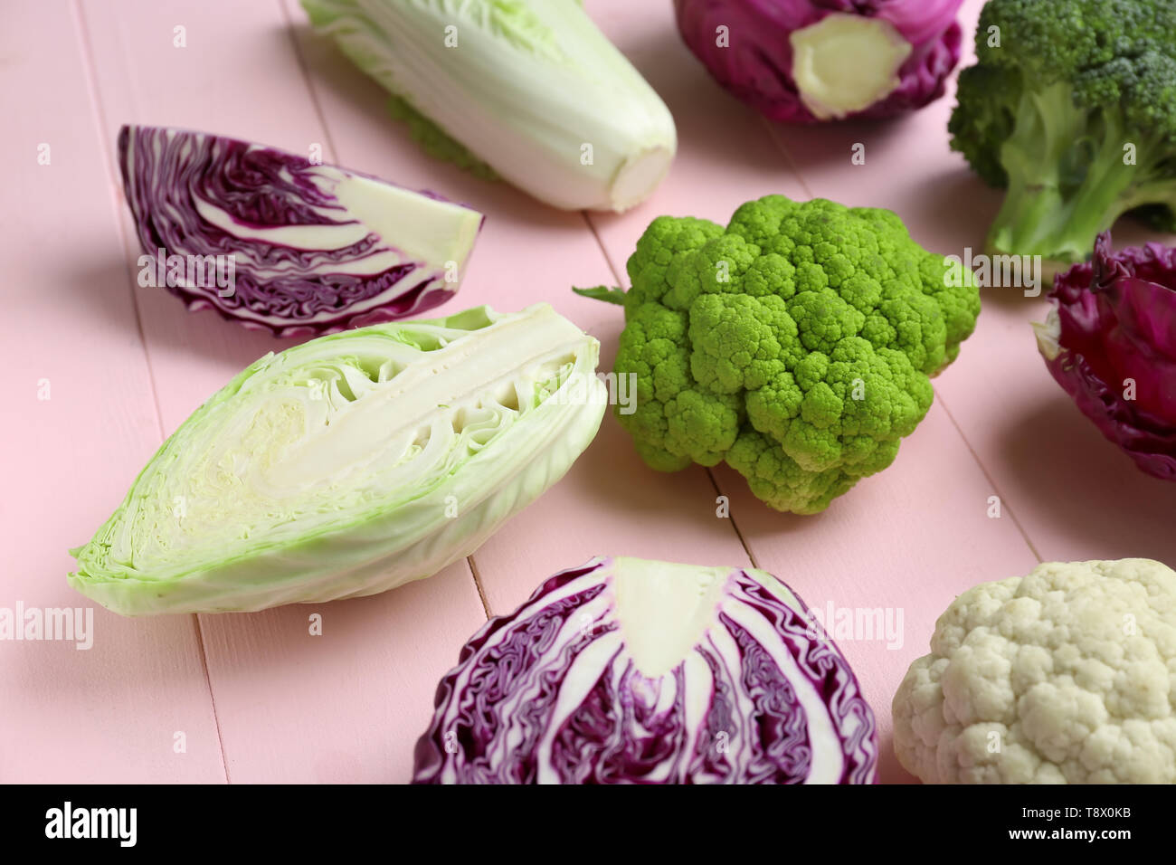 Different kinds of cabbage on color wooden background Stock Photo - Alamy