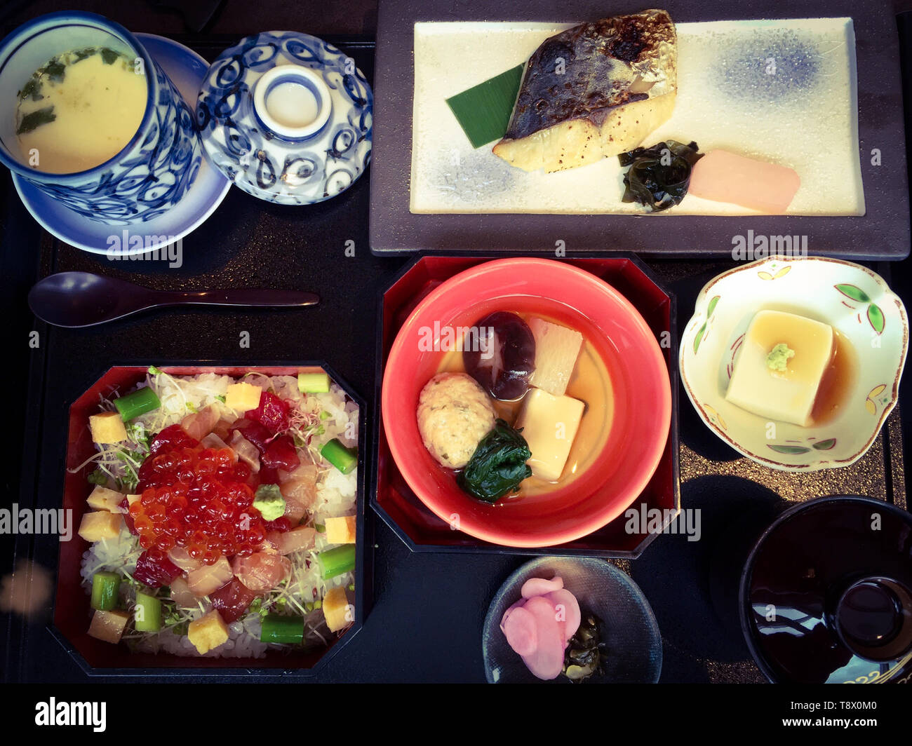 Top view of a traditional Japanese meal, with dishes of fried fish ...