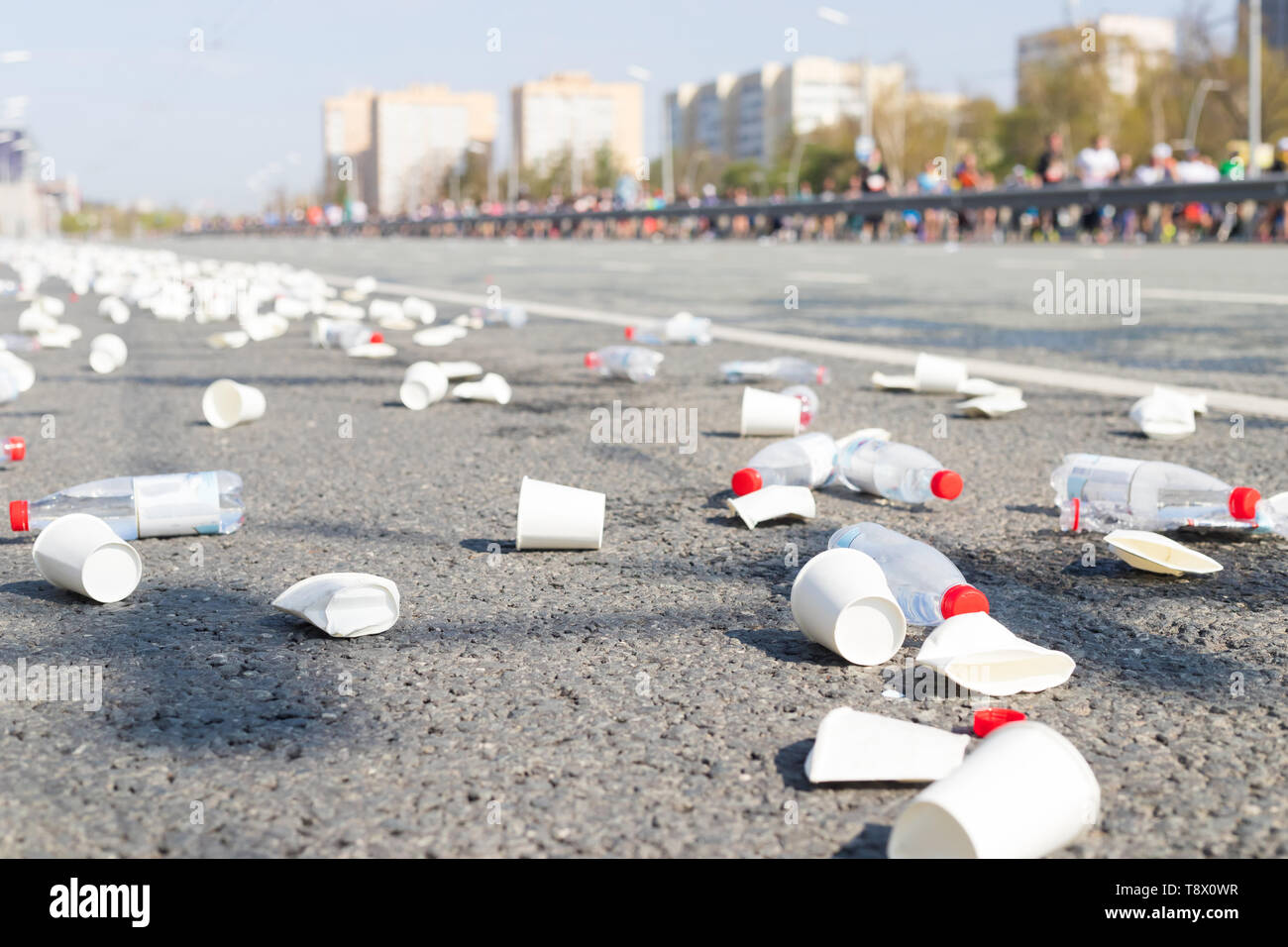 A bunch of plastic cups and empty bottles on the road while a marathon ...